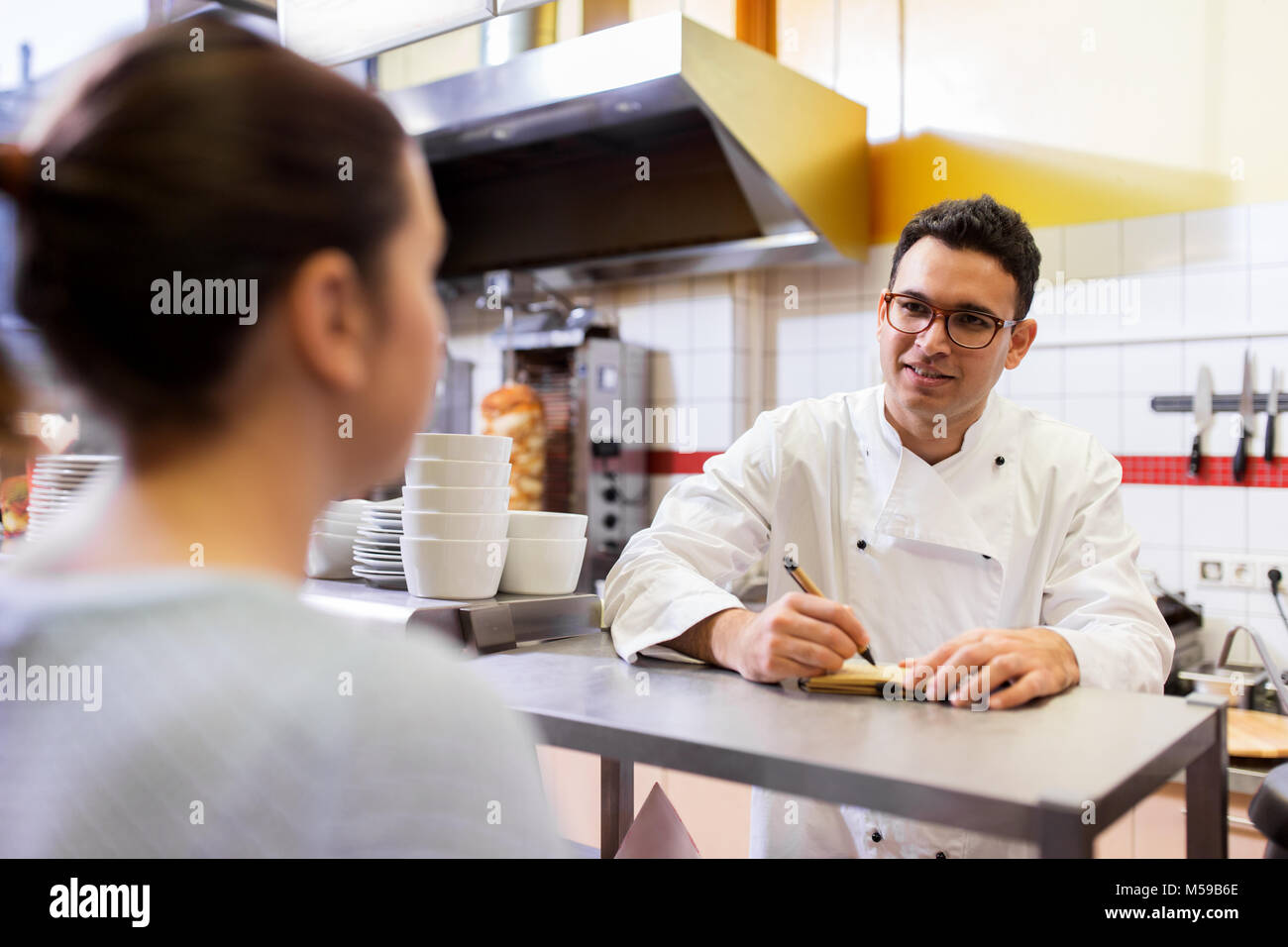 chef at fast food restaurant writing order Stock Photo - Alamy