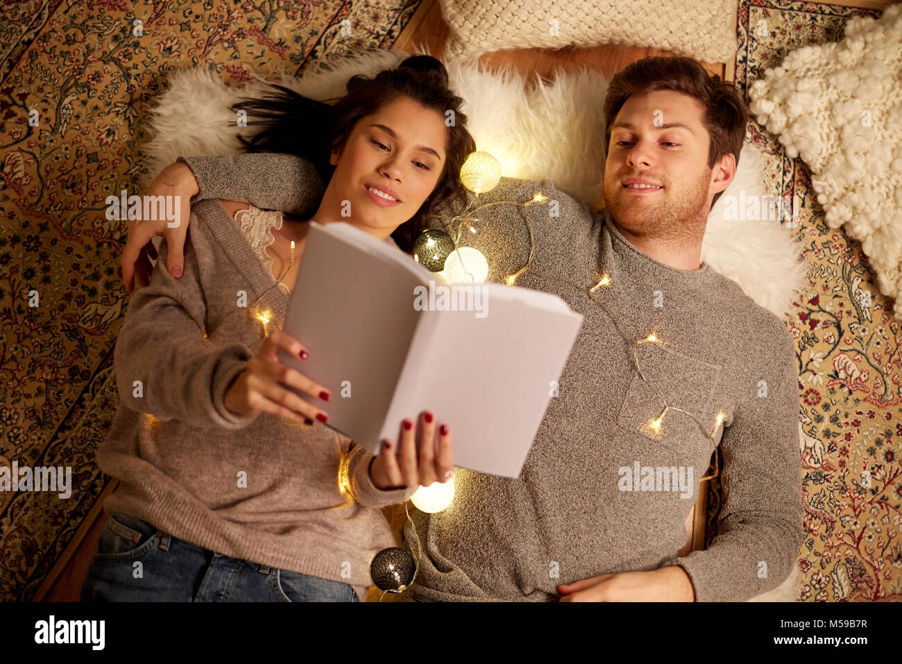happy couple reading book at home Stock Photo - Alamy