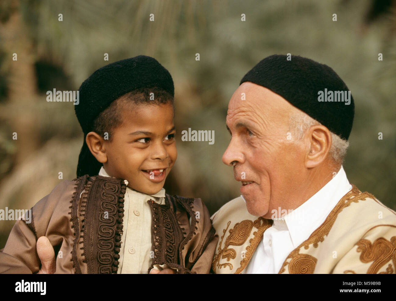 Libya. Ghadames oasis. Sahara desert. Local Berber boy and man dressed ...