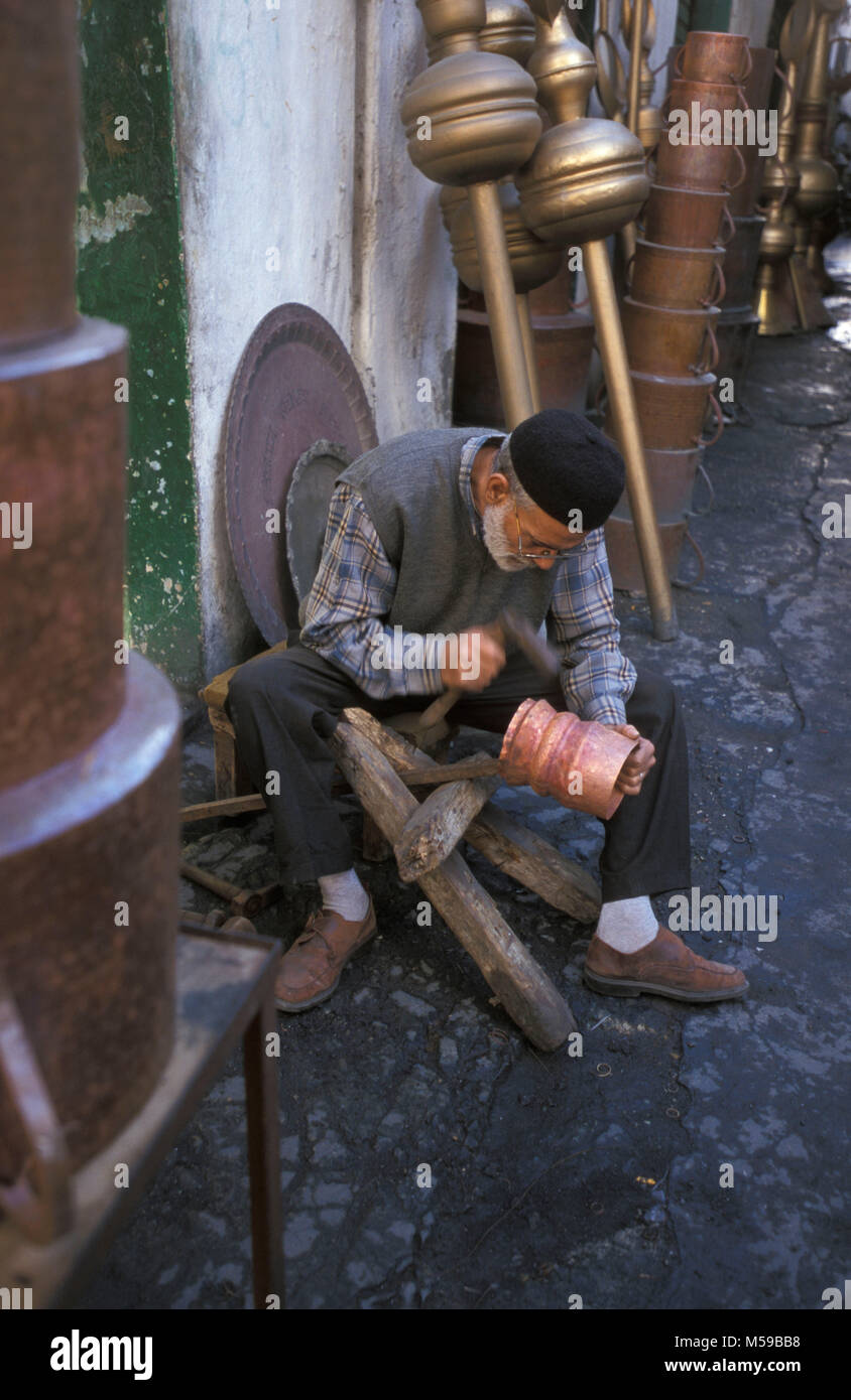 Libya. Tripoli. Old City. Coppersmith making copper objects Stock Photo ...