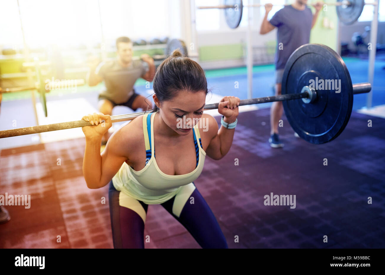 group of people training with barbells in gym Stock Photo - Alamy