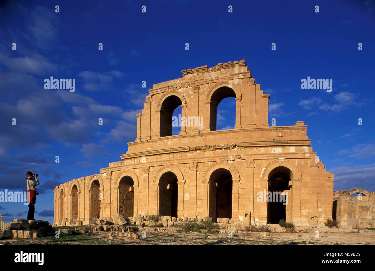 Libya. Tripoli. Sabratha. (Sabrata). Roman ruins. Tourist taking photograph. Unesco, World ...