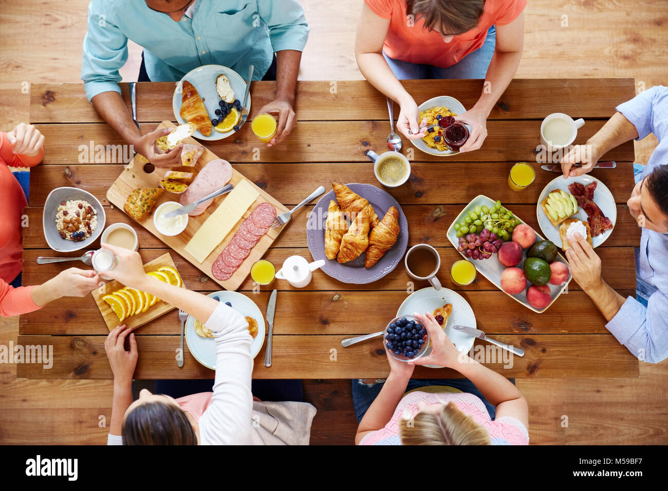 group of people having breakfast at table Stock Photo - Alamy
