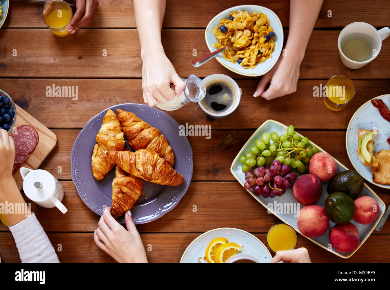 group of people having breakfast at table Stock Photo - Alamy