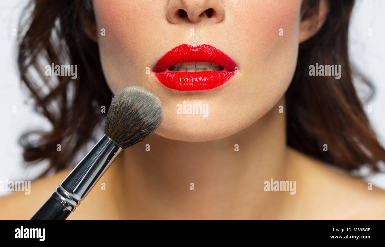 face of woman with red lipstick applying powder Stock Photo - Alamy