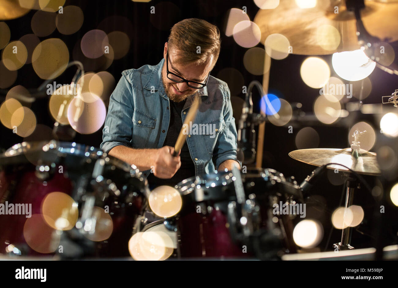 male musician playing drums and cymbals at concert Stock Photo - Alamy