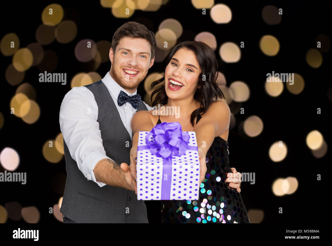 Surprise party concept man giving gift box to woman hi-res stock ...