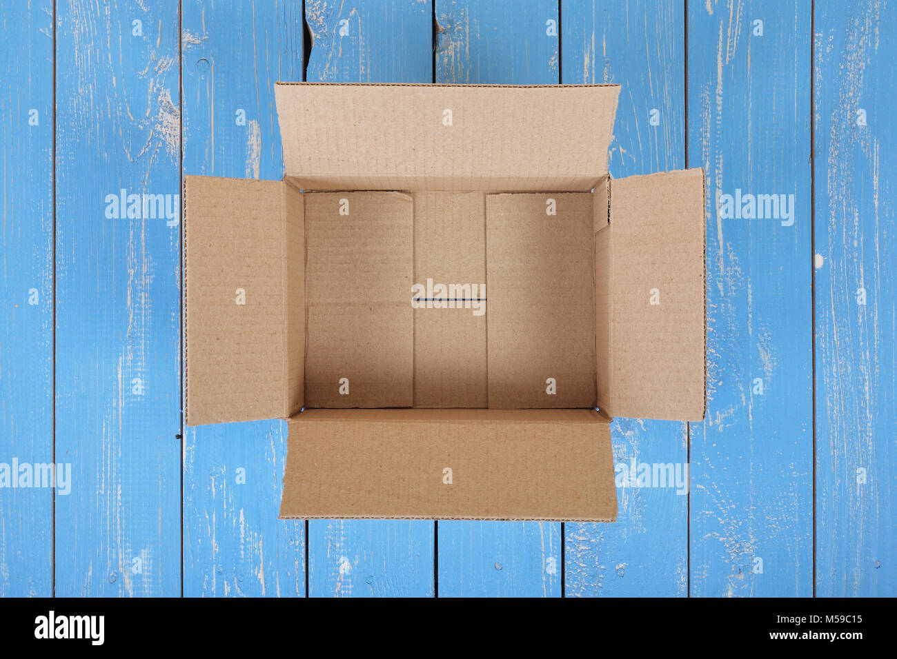 Postage and packing service - Open Package top view on a blue wood ...