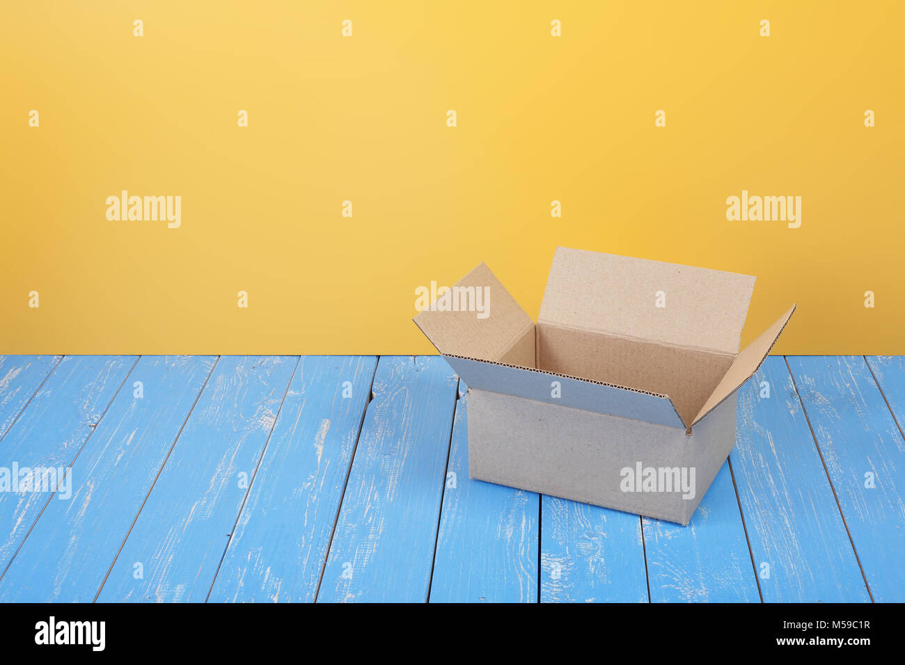 Postage and packing service - Open Package front view on a blue wood ...