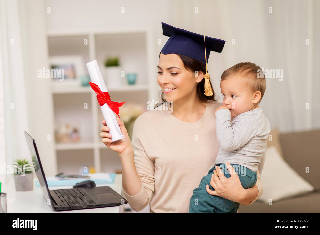 mother student with baby boy and diploma at home Stock Photo - Alamy