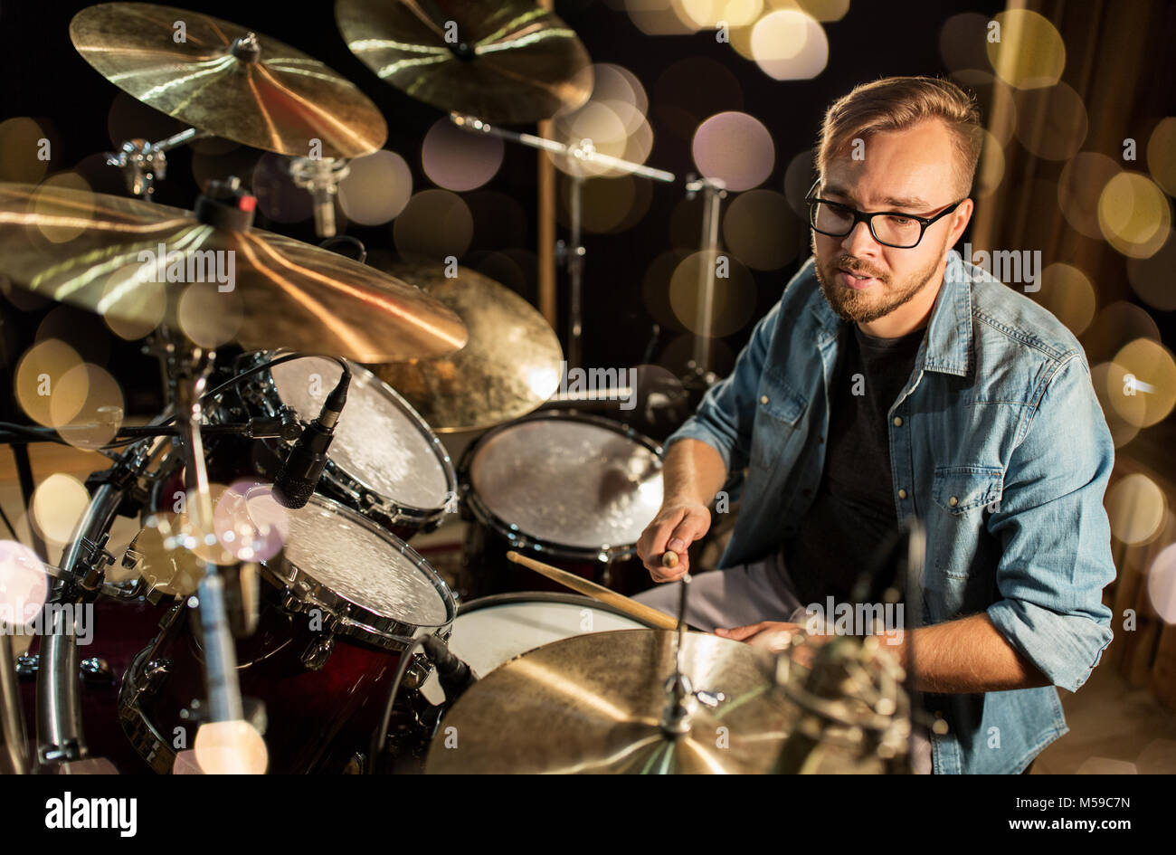 male musician playing drums and cymbals at concert Stock Photo - Alamy