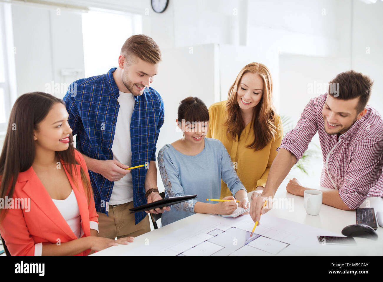 creative team with blueprint working at office Stock Photo - Alamy