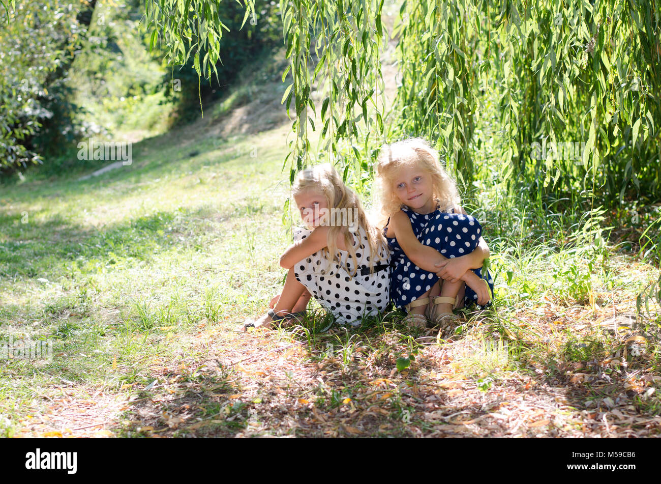 Two girls under tree hi-res stock photography and images - Alamy
