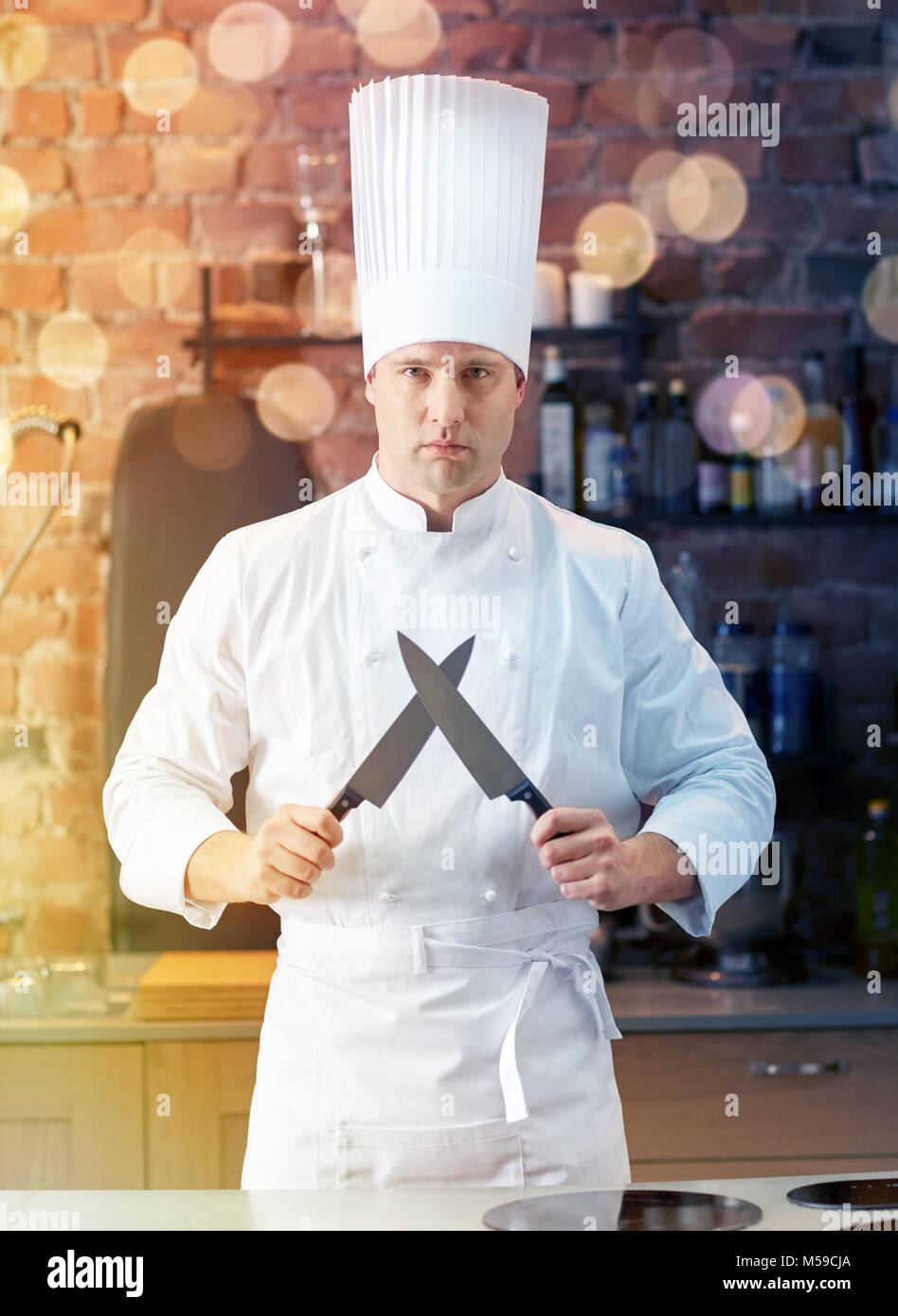 happy male chef cook in kitchen with knife Stock Photo - Alamy