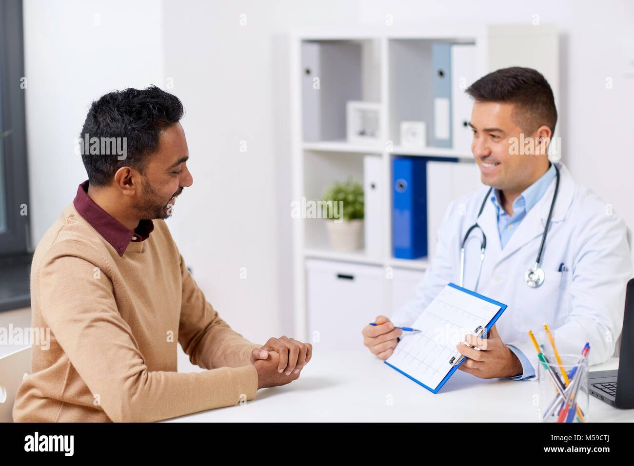 happy doctor and male patient meeting at hospital Stock Photo - Alamy