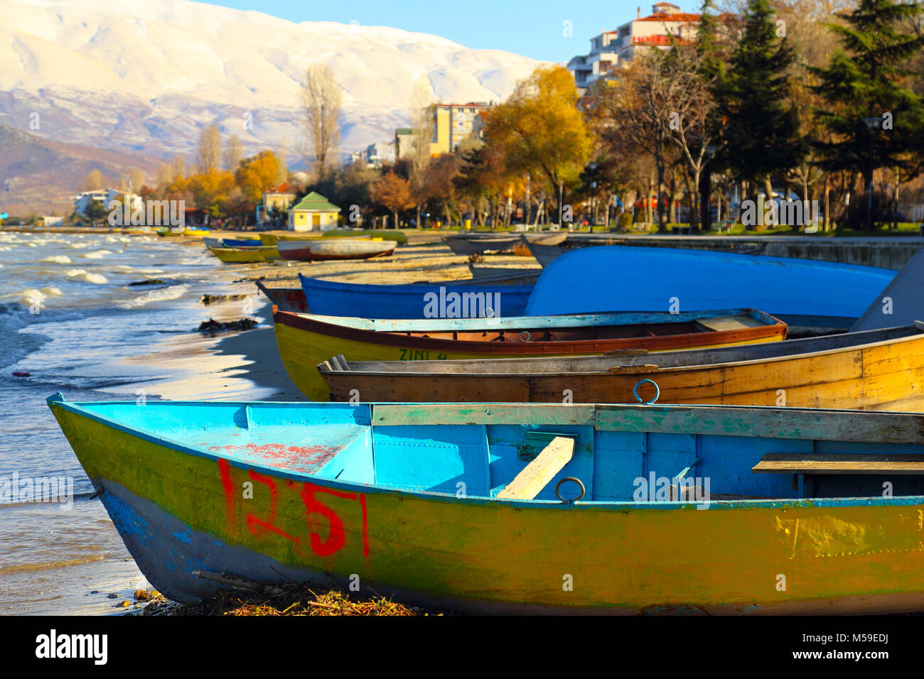 Wooden fishing boats moored on the beach of Lake Ohrid in Pogradec ...