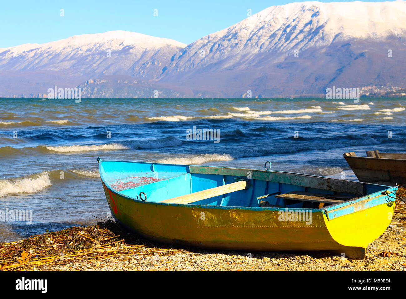 Wooden fishing boats moored on the beach of Lake Ohrid in Pogradec ...