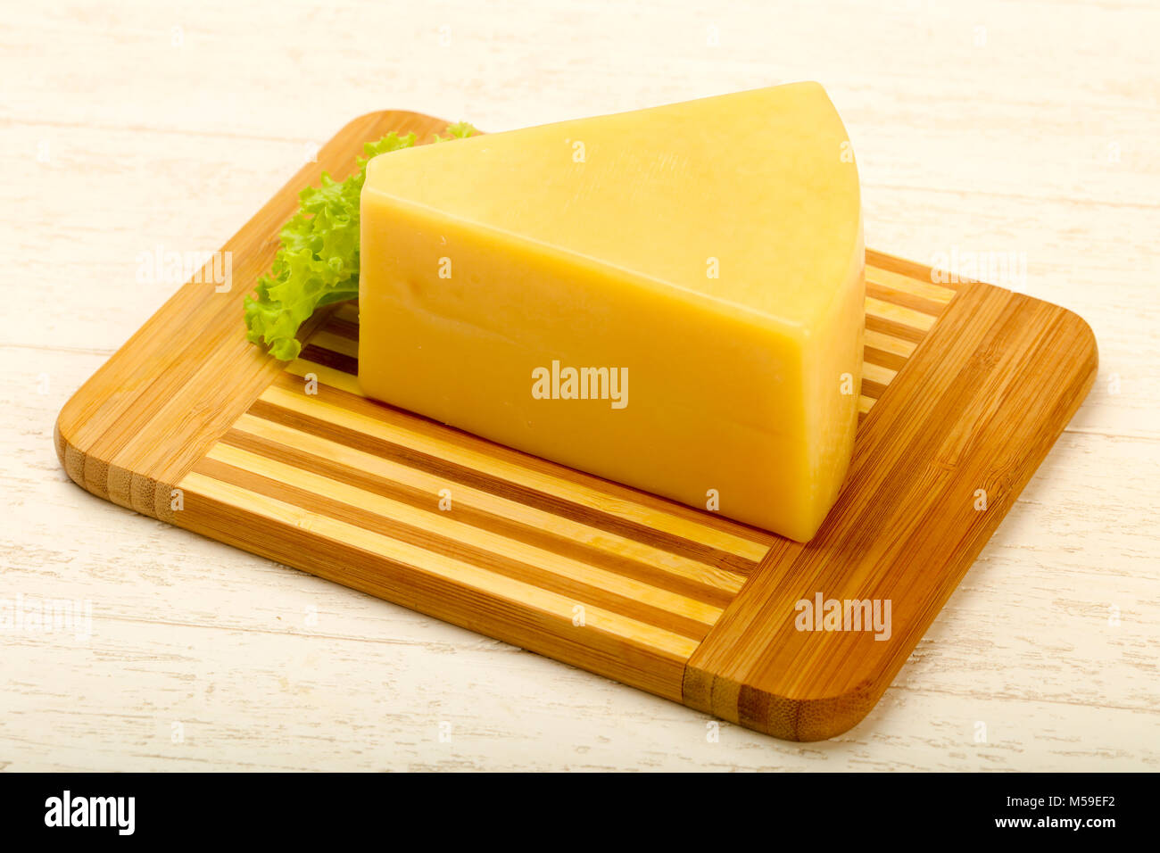 Parmesan cheese triangle Stock Photo - Alamy