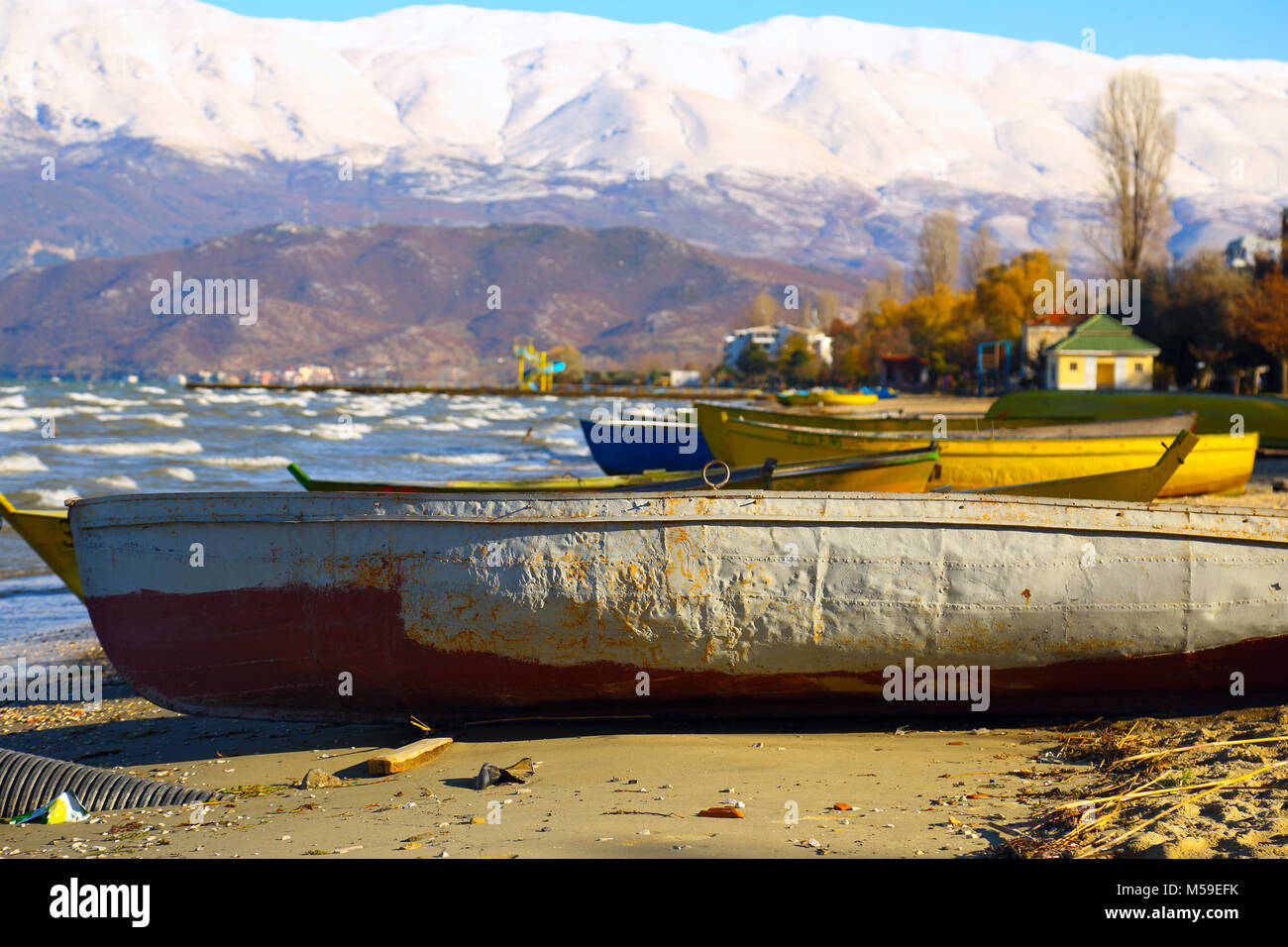 Wooden fishing boats moored on the beach of Lake Ohrid in Pogradec ...