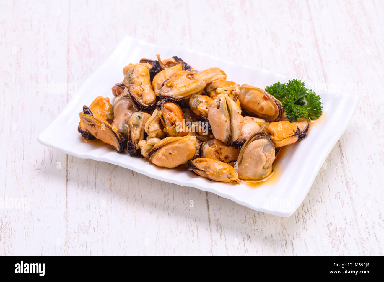 Pickled mussels in the bowl served parsley Stock Photo - Alamy