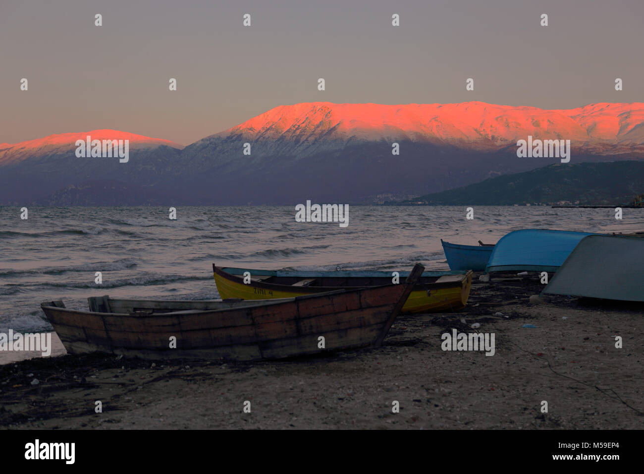 Wooden fishing boats moored on the beach of Lake Ohrid in Pogradec ...