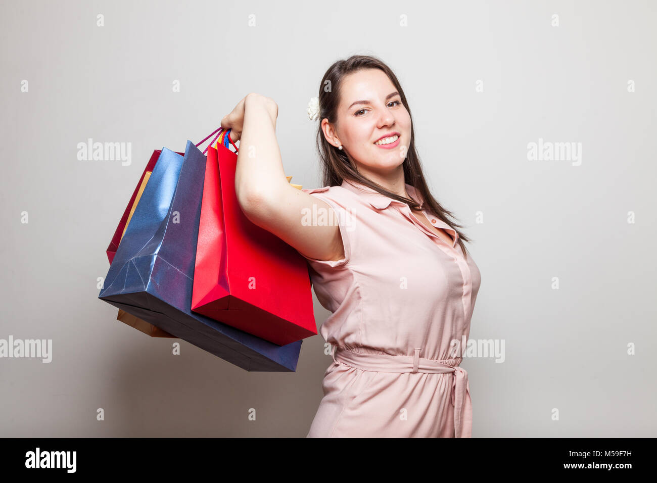 Attractive woman poses with shopping bags Stock Photo - Alamy