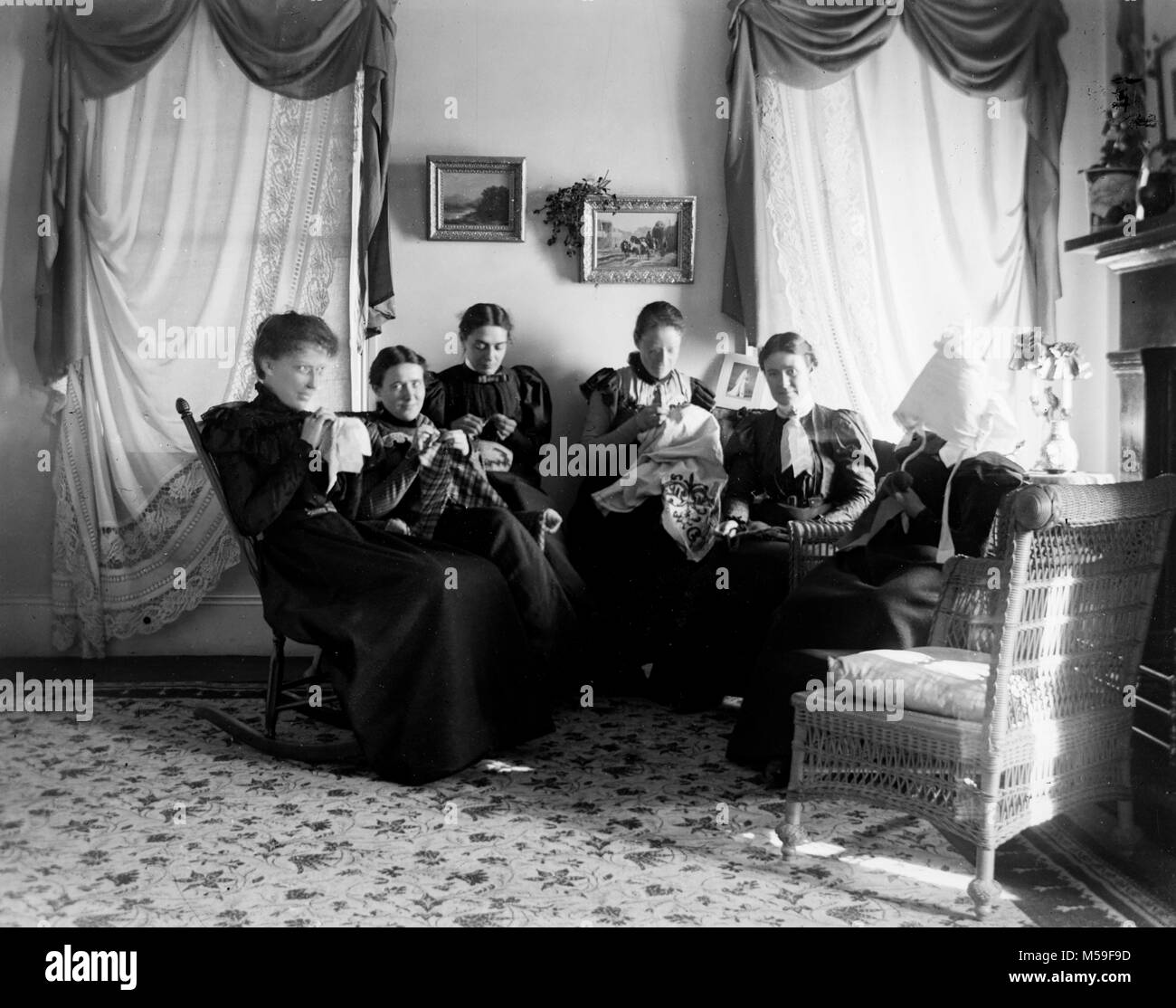 Needlepoint party in the living room for group of women, ca. 1900 Stock ...