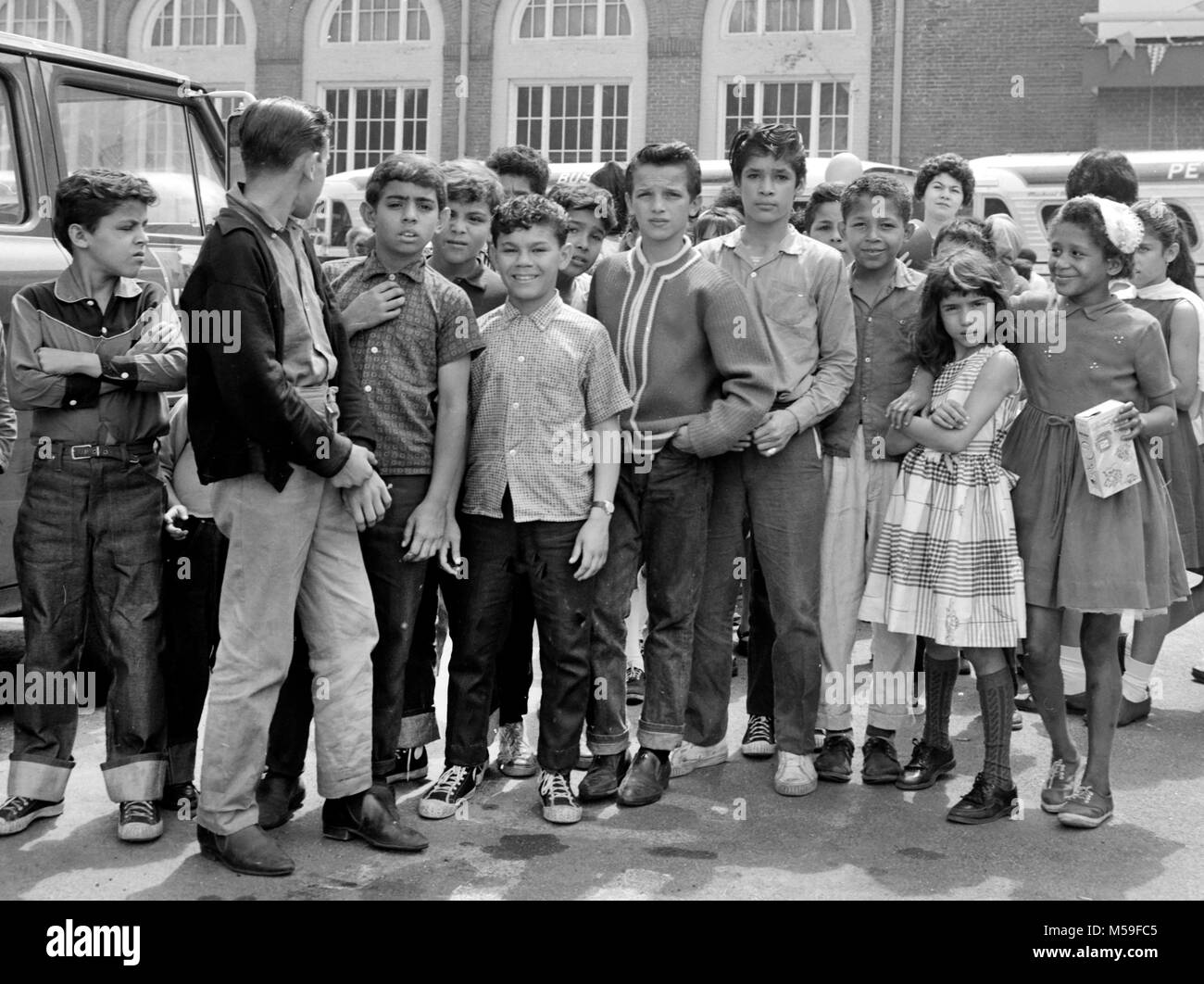 Multi-race group of children gather in a parking lot in New England, ca ...