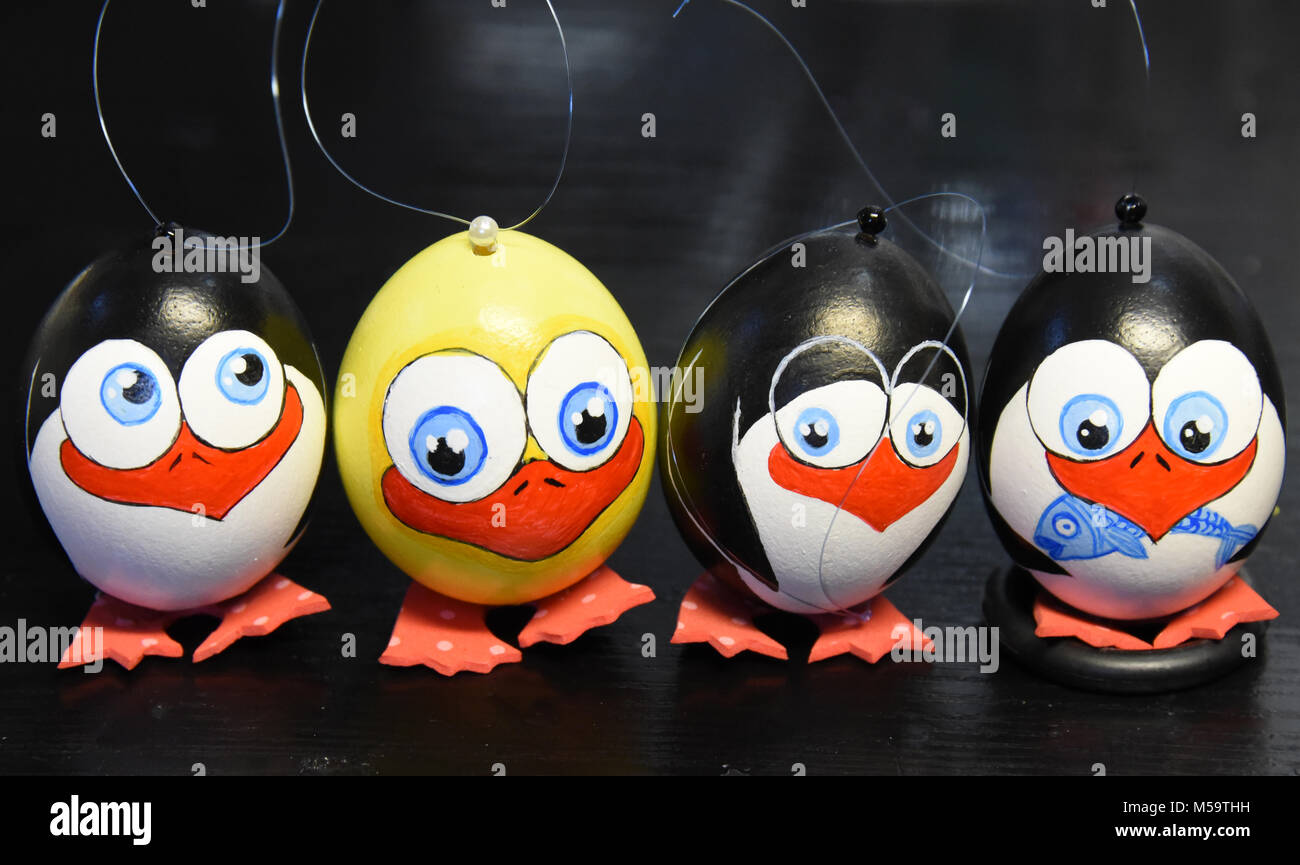 Easter eggs decorated as penguines and a duck (2nd L) created by Easter ...