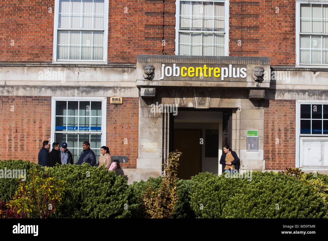 Leeds, UK - 2018. People standing outside at Job Centre Plus office in ...