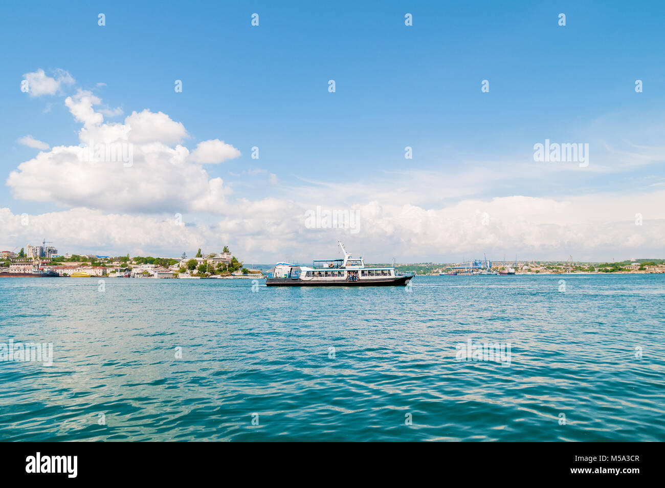 Passenger boat ferry on the sea water in the city center Stock Photo ...