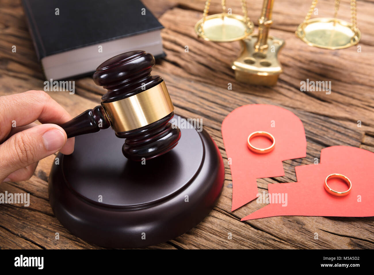 Judge hitting mallet by broken paper heart with rings and justice scale ...