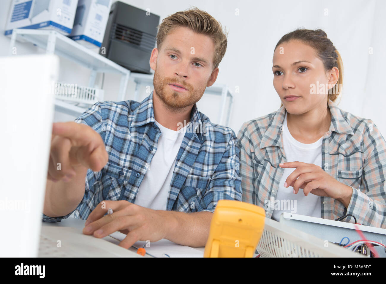 workers checking mutimeters result Stock Photo - Alamy
