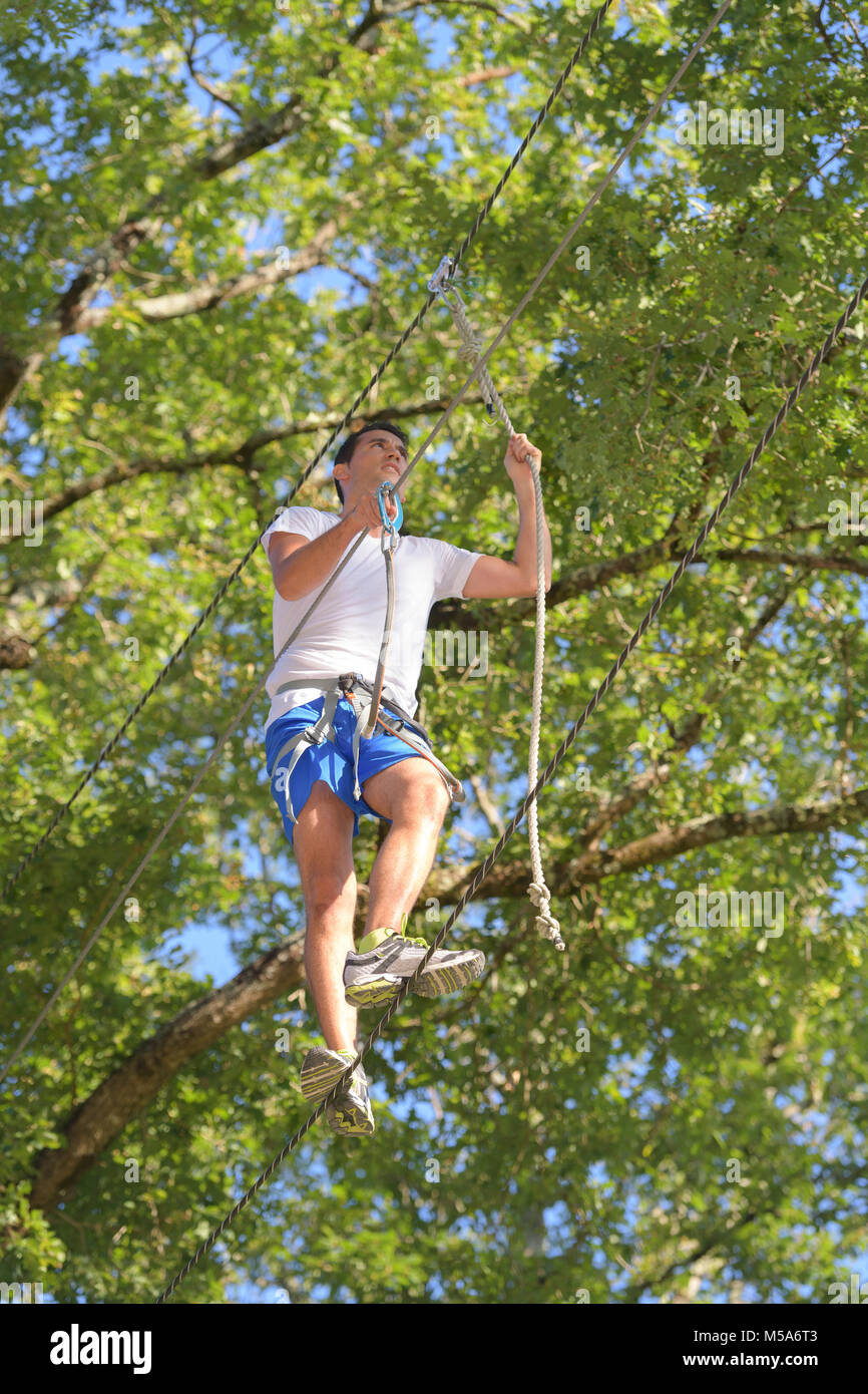 male climber in the adventure park Stock Photo - Alamy