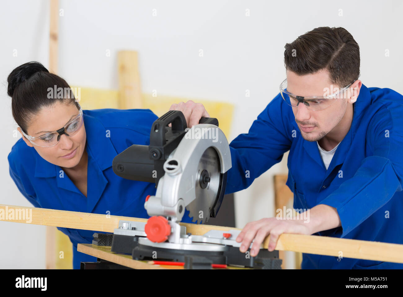 students in carpentry class using circular saw Stock Photo - Alamy