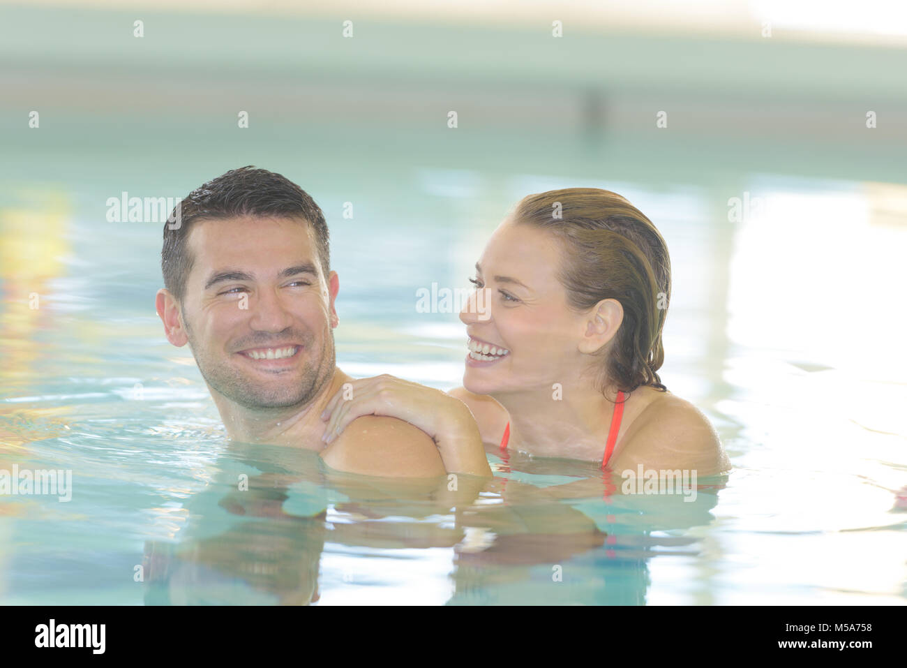 couple swimming pool relationship concept Stock Photo - Alamy