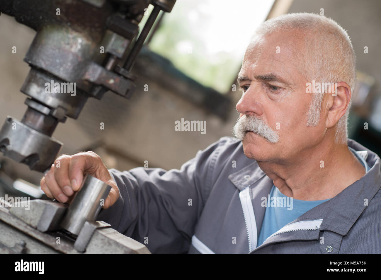 senior worker using a milling machine Stock Photo - Alamy