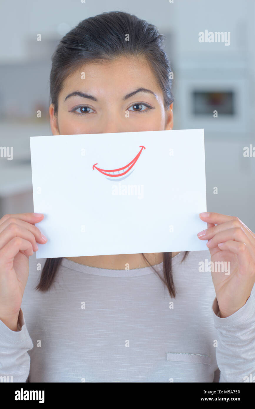 woman showing a happy emoticon in front of face Stock Photo - Alamy