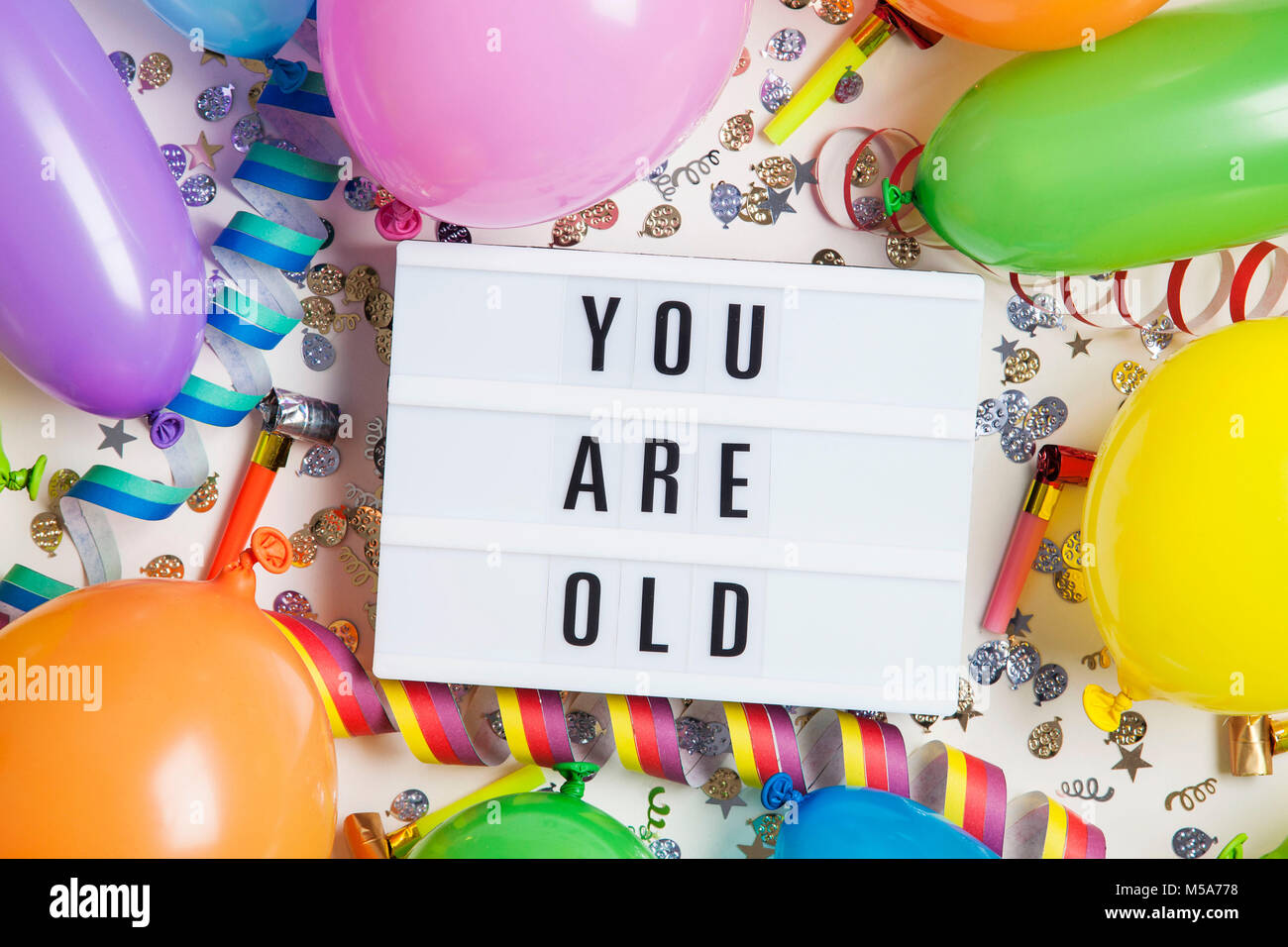 Party celebration background with you are old message on a lightbox ...
