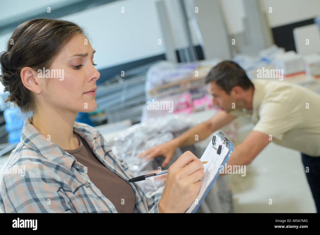 warehouse manager checking inventory in a large warehouse Stock Photo ...