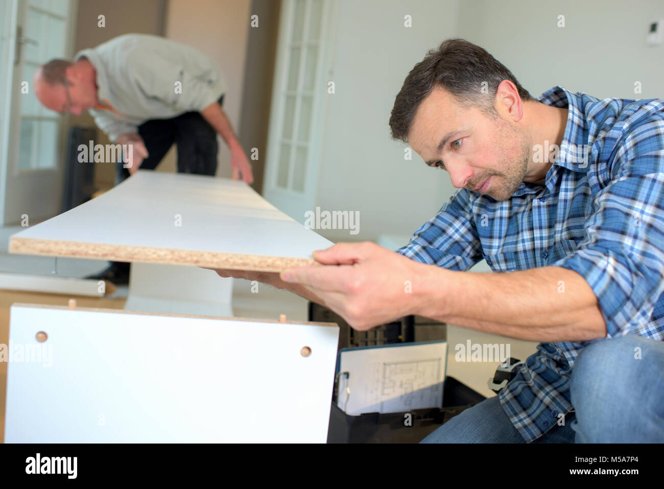 Putting together flap pack furniture Stock Photo - Alamy