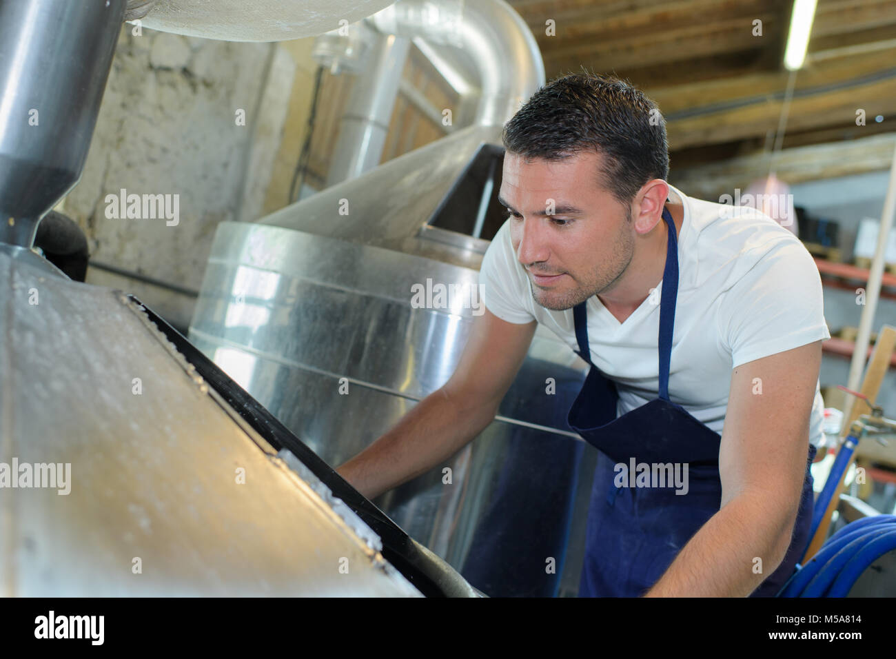 young man working in food factory Stock Photo - Alamy