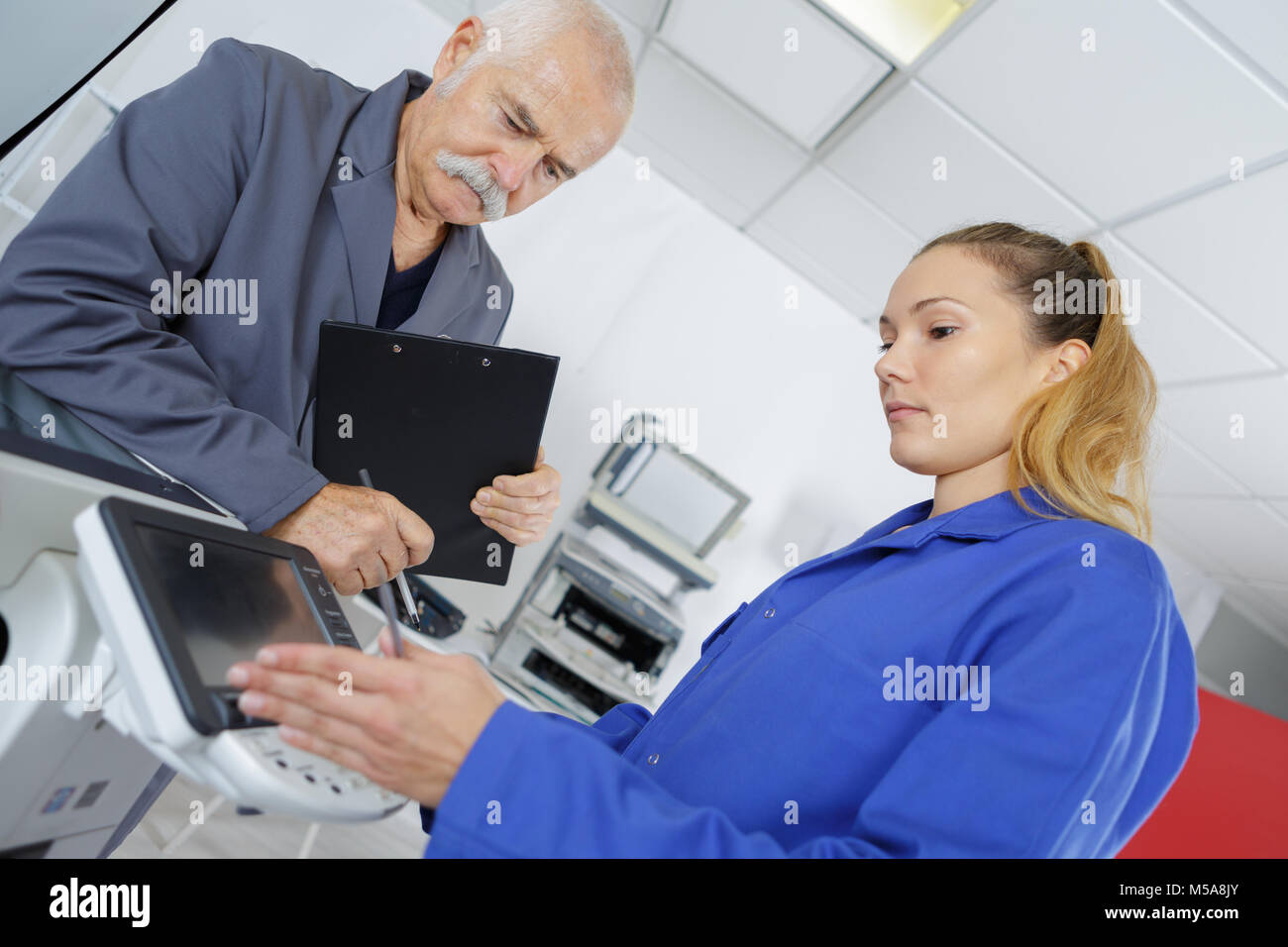 experienced engineer with his young female trainee Stock Photo - Alamy