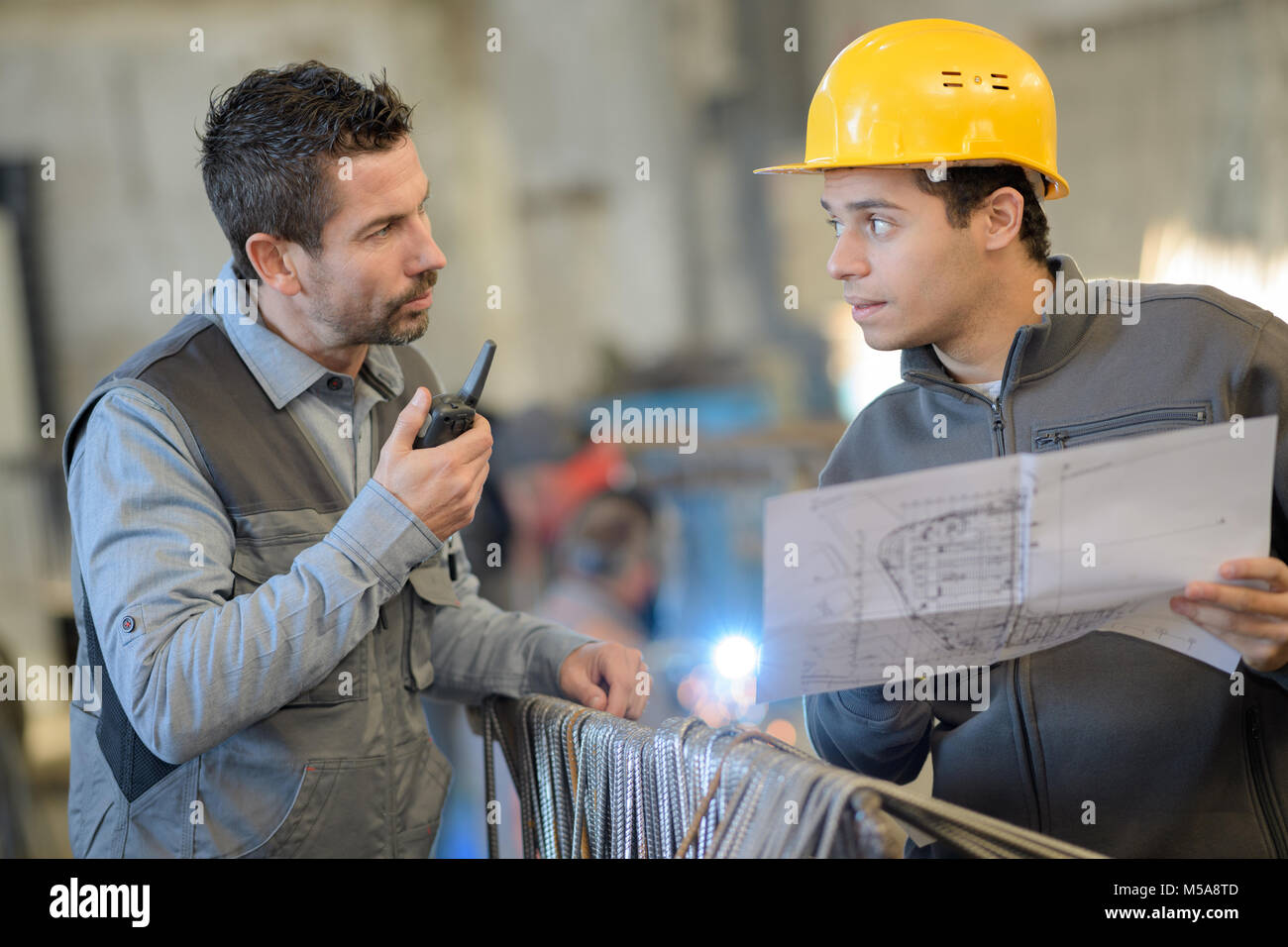 manager with storeman controlling factory planss Stock Photo - Alamy