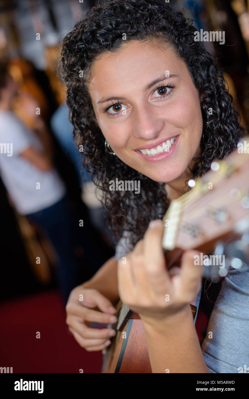 young and beautiful rock girl playing the electric guitar Stock Photo ...