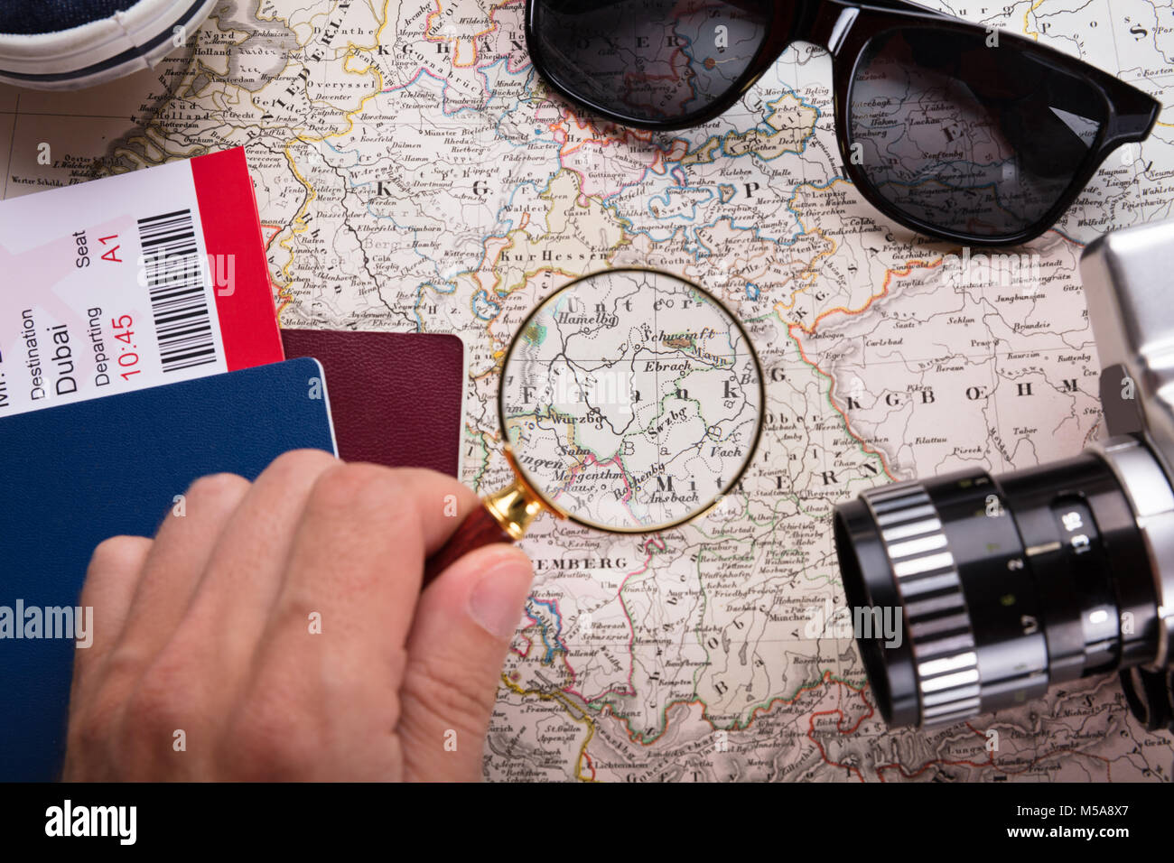 Boarding Pass Ticket And Camera With Human Hand Looking At Map With ...