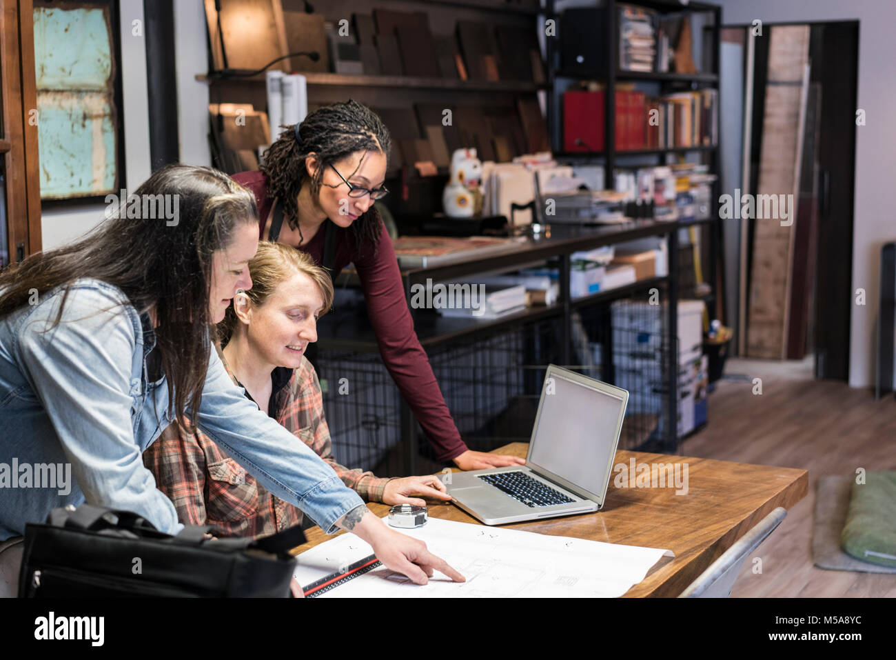 Group standing around desk in hi-res stock photography and images - Alamy