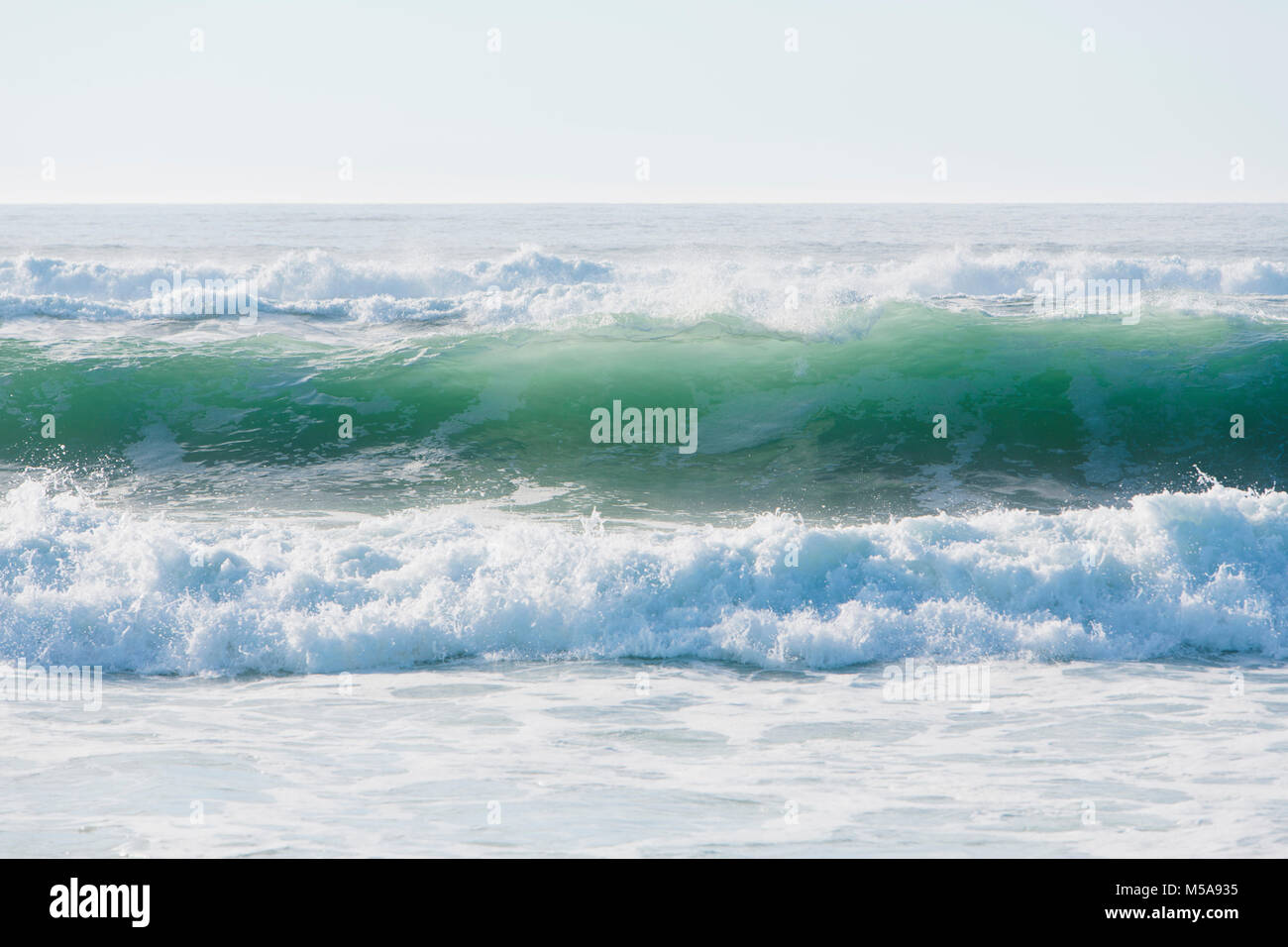 Seascape with breaking waves on sandy beach Stock Photo - Alamy