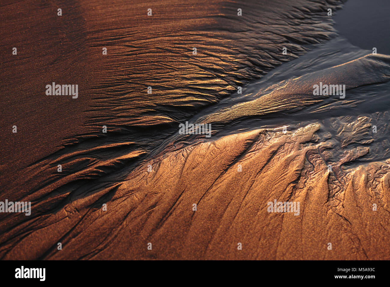 High angle close up of patterns in beach sand at dusk Stock Photo - Alamy