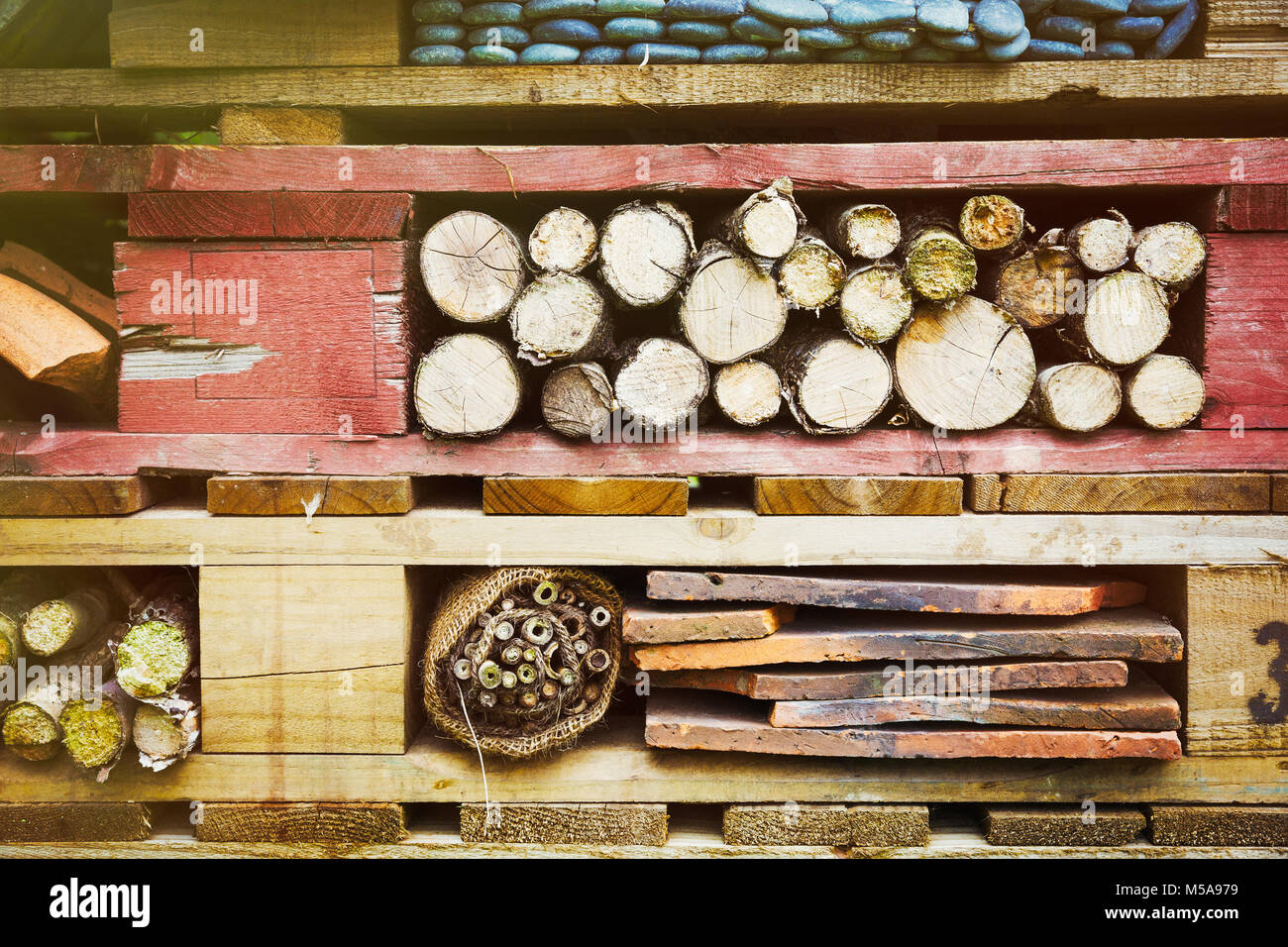 Close up of large bug house with several layers of different materials ...
